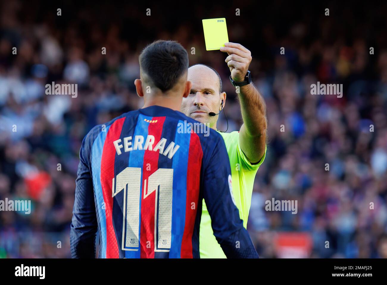 BARCELONA - DEC 31: The referee Lahoz shows a yellow card to Torres during the LaLiga match ...