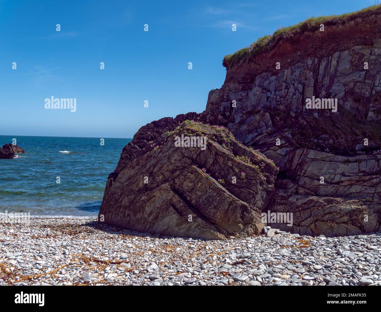 A beach on the Irish coast of the Atlantic Ocean on a sunny day ...
