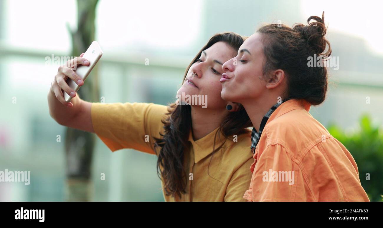 Candid authentic women using smartphone outside laughing reaction ...