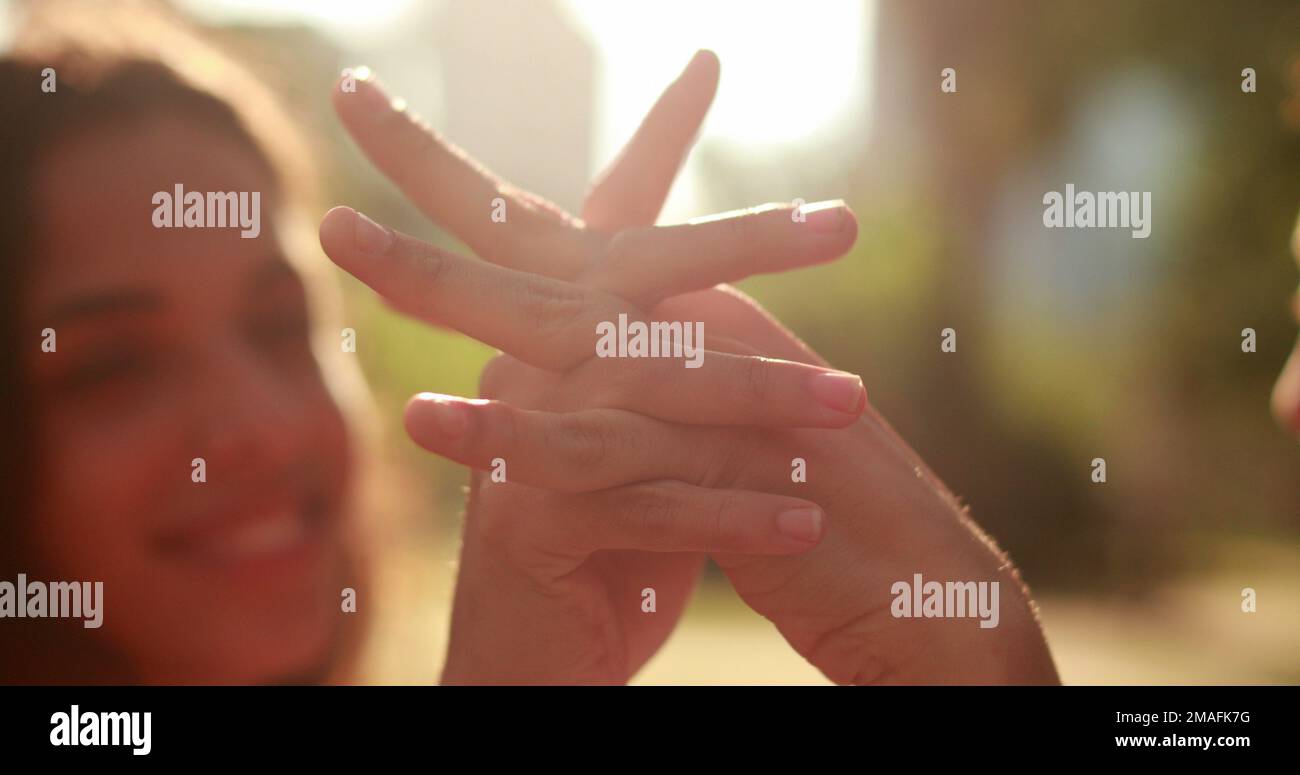 Friends celebrating union by joining hands together outdoors Stock Photo - Alamy