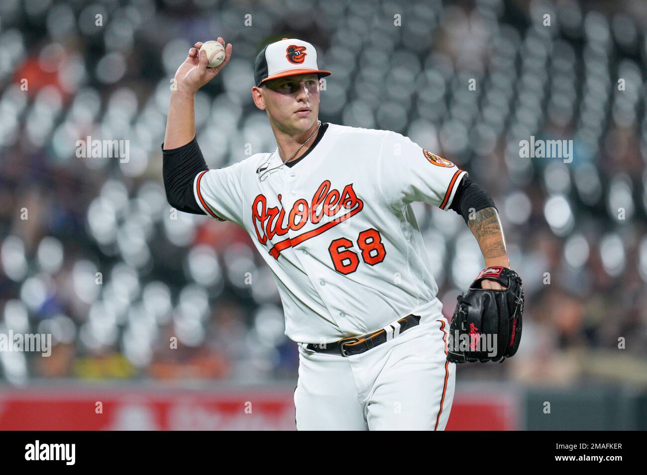 Baltimore Orioles starting pitcher Tyler Wells throws to first base ...