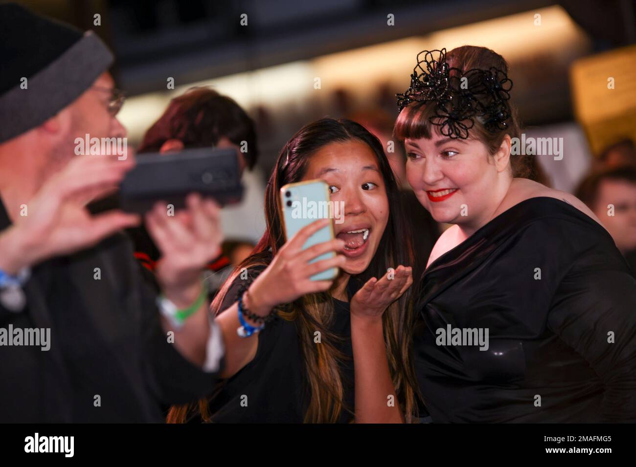 Director Lena Dunham, right, poses for a selfie upon arrival for the UK ...