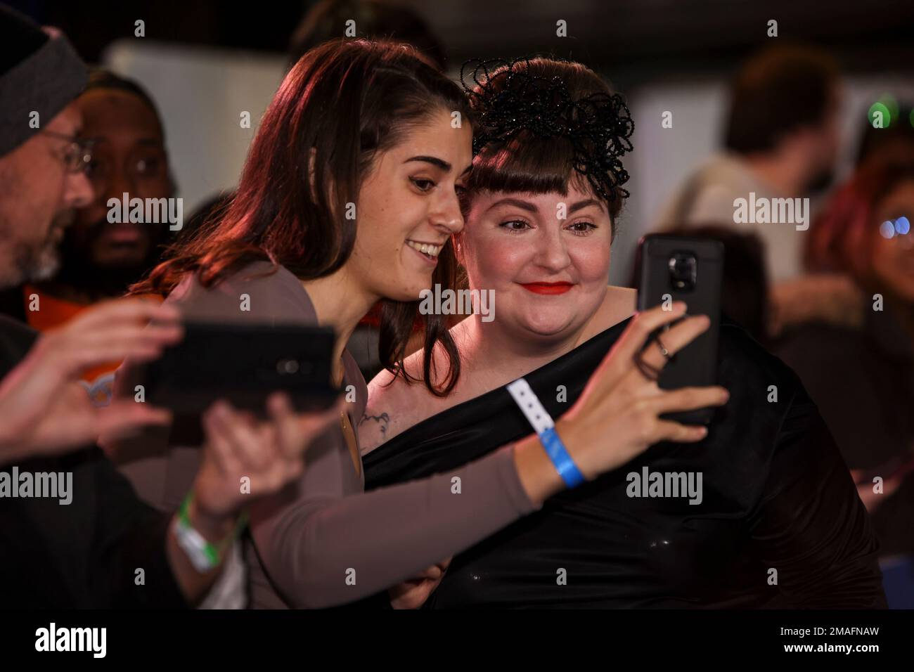 Director Lena Dunham, right, poses for selfies upon arrival for the UK ...
