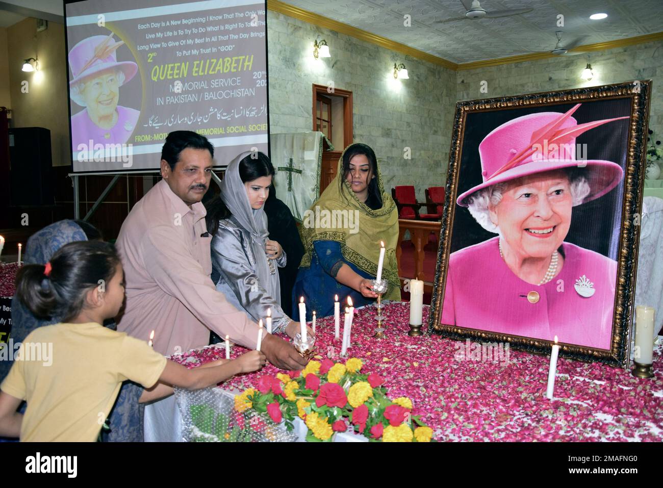 A portrait of the late Queen Elizabeth II is on display as people pay ...