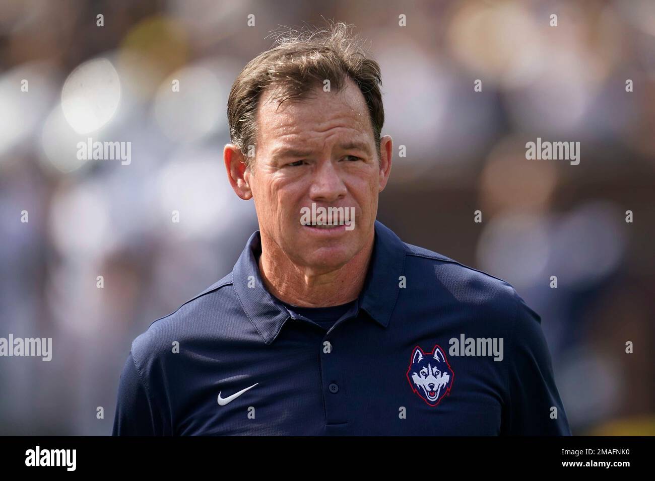 Connecticut head coach Jim Mora watches before an NCAA college football ...
