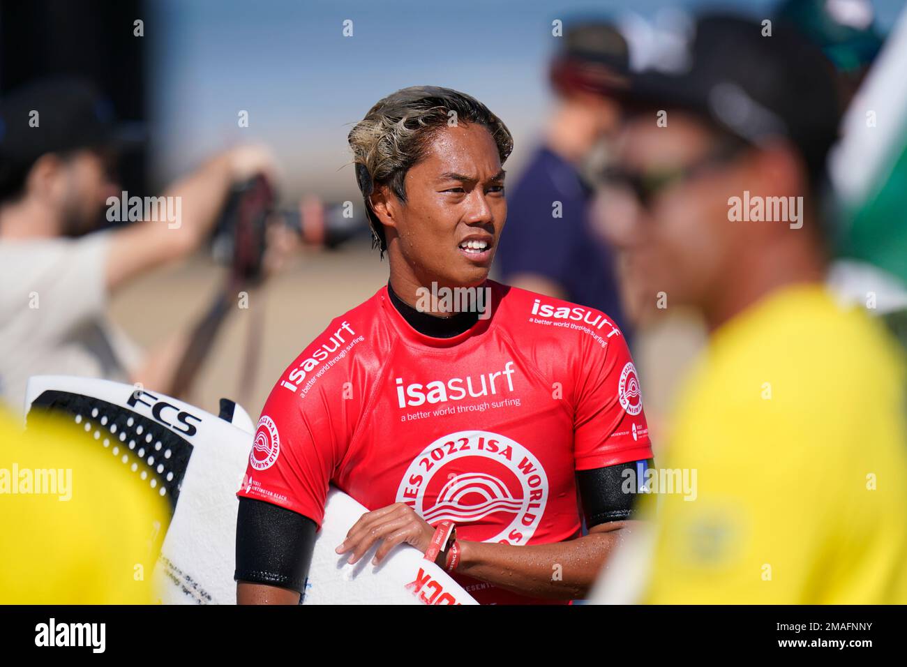 Keanu Kamiyama, of Japan, walks on the sand after competing in the ISA ...