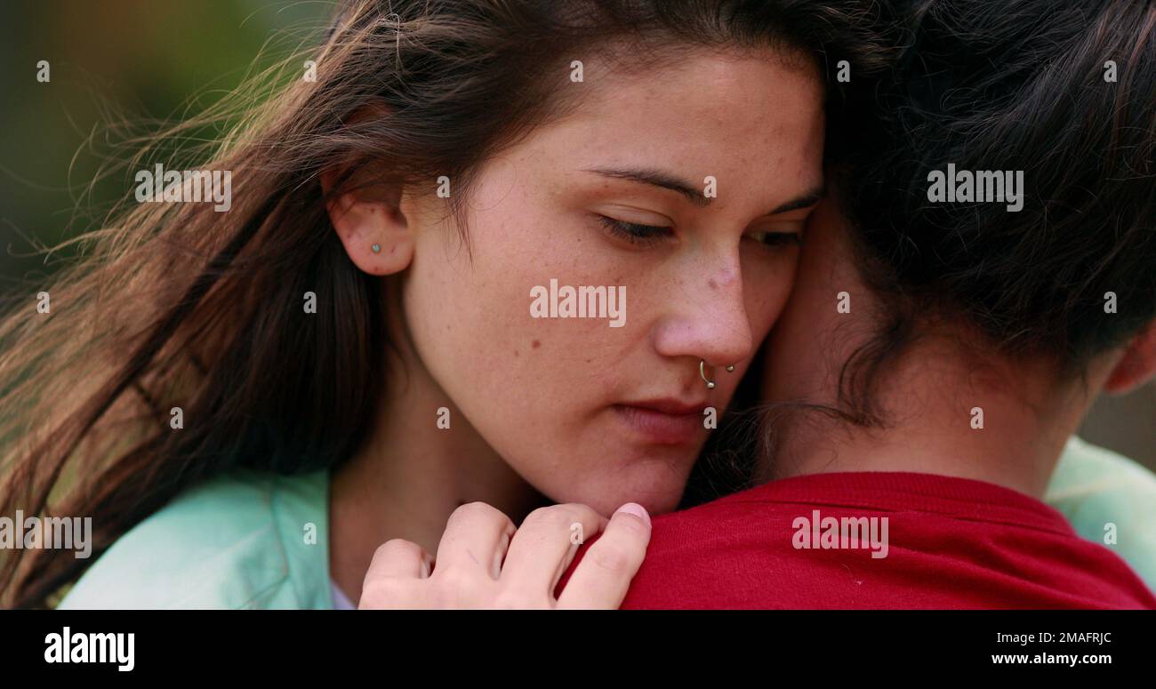 Girlfriends hugging and embracing each other. Two young women hug Stock ...
