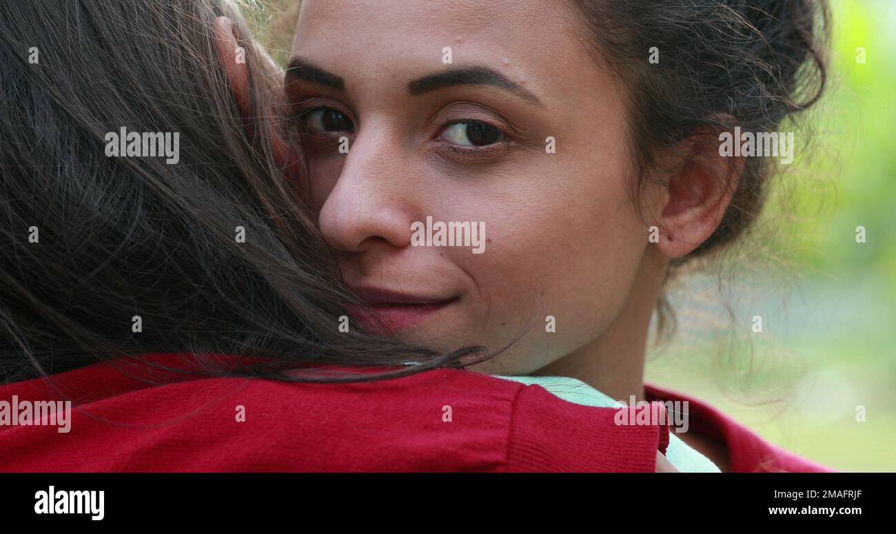 Girlfriend hugging lover embrace. Young woman face cuddling Stock Photo ...