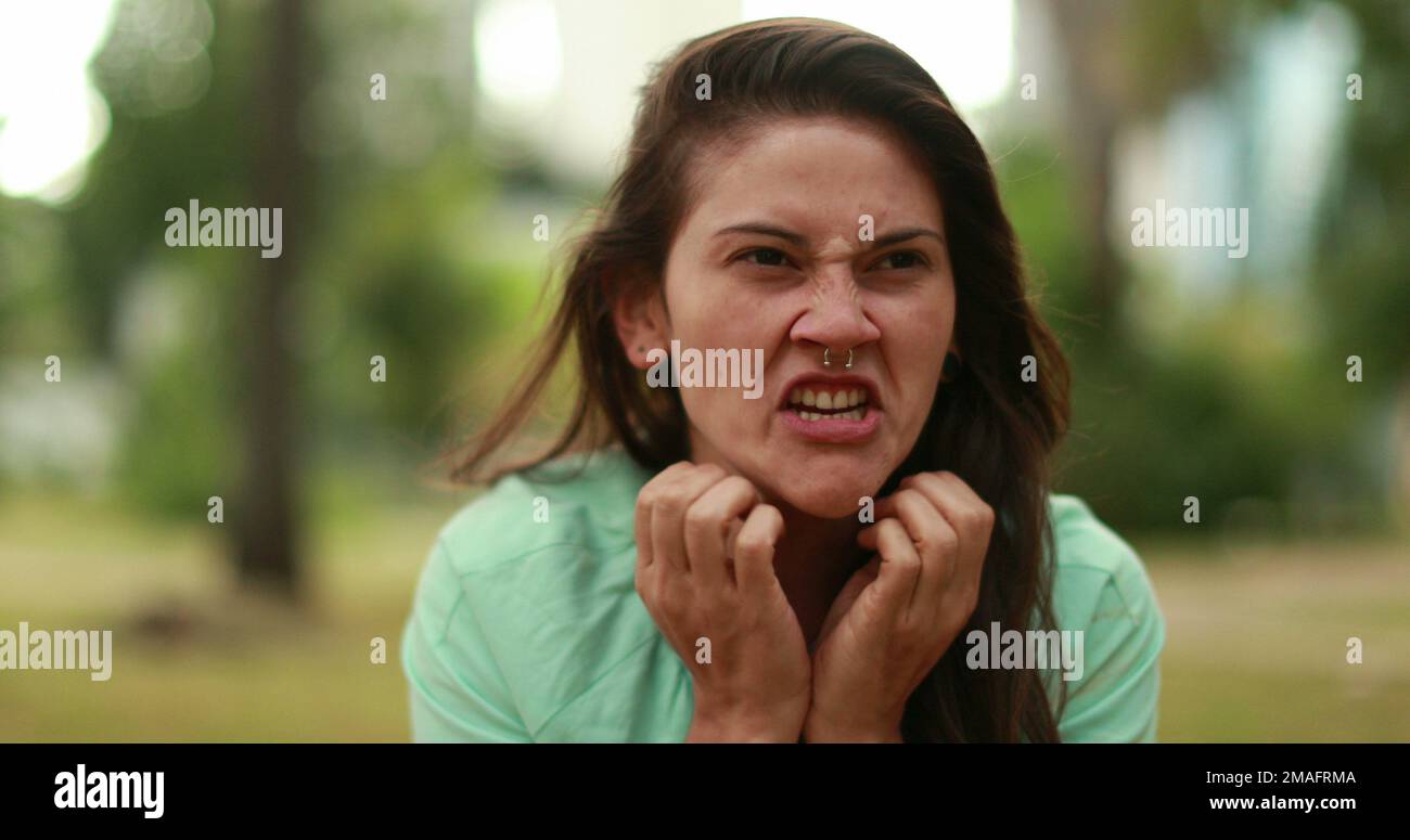Furious young woman yelling outside feeling anxiety and stress Stock ...