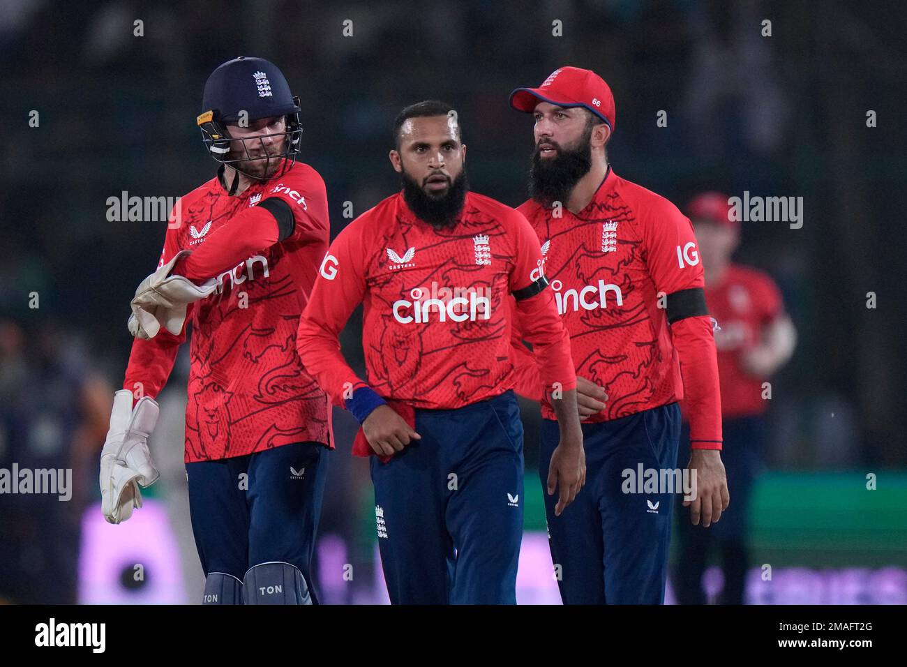 England's Adil Rashid, center, and teammates celebrate the dismissal of ...
