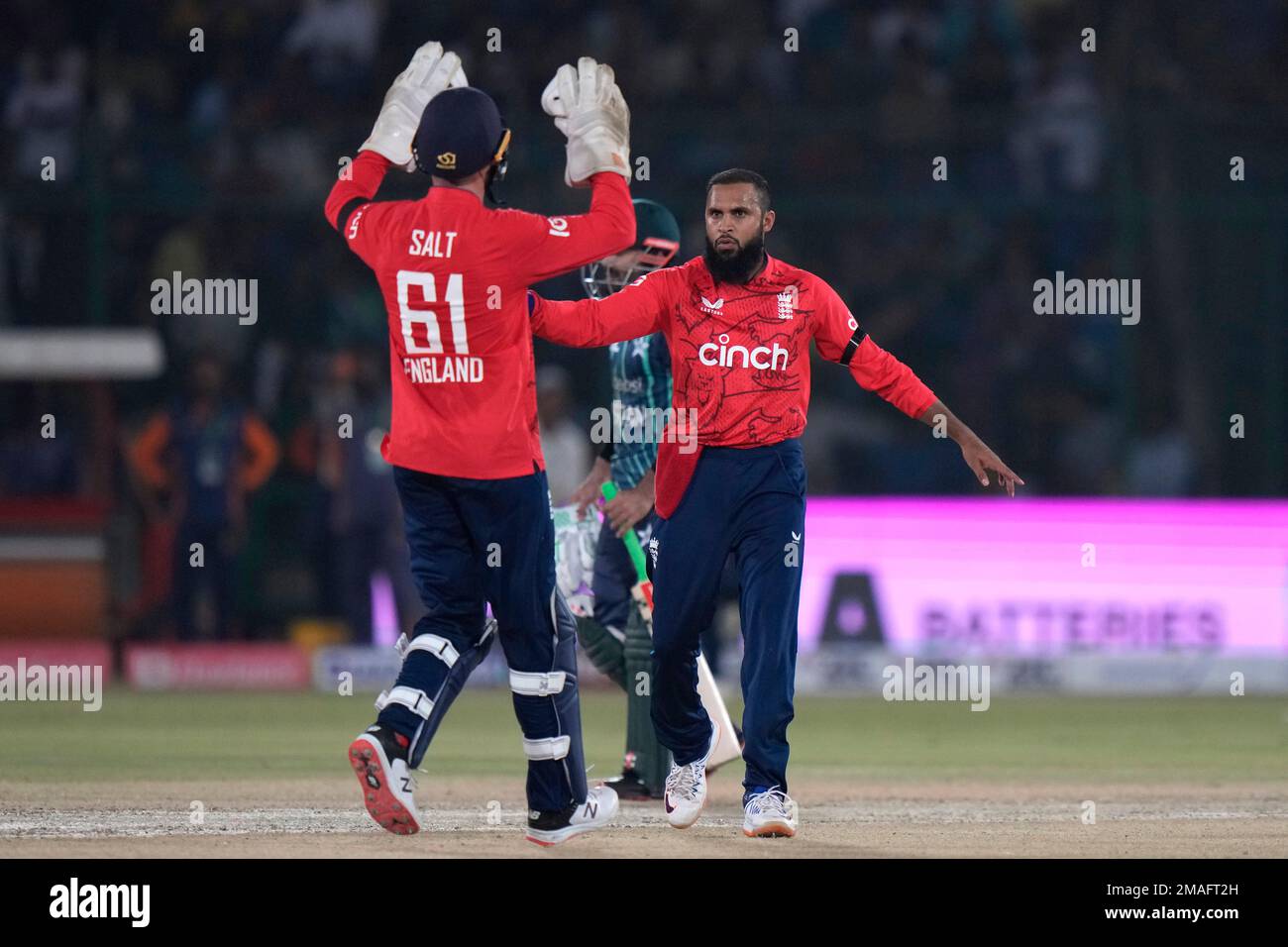 England's Adil Rashid, right, celebrates with teammates the dismissal ...