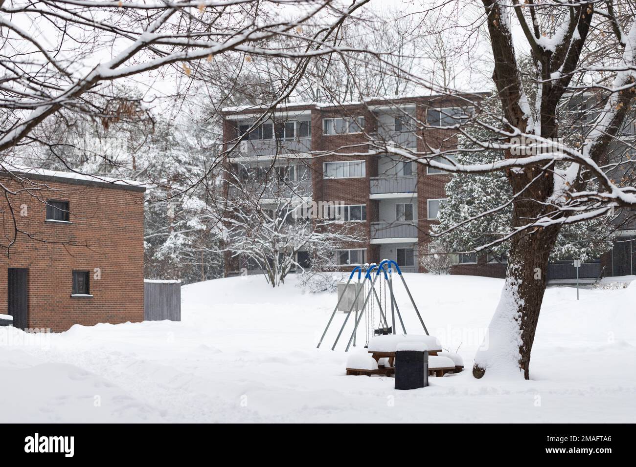 Winter snowy day in residential area near apartment building with ...