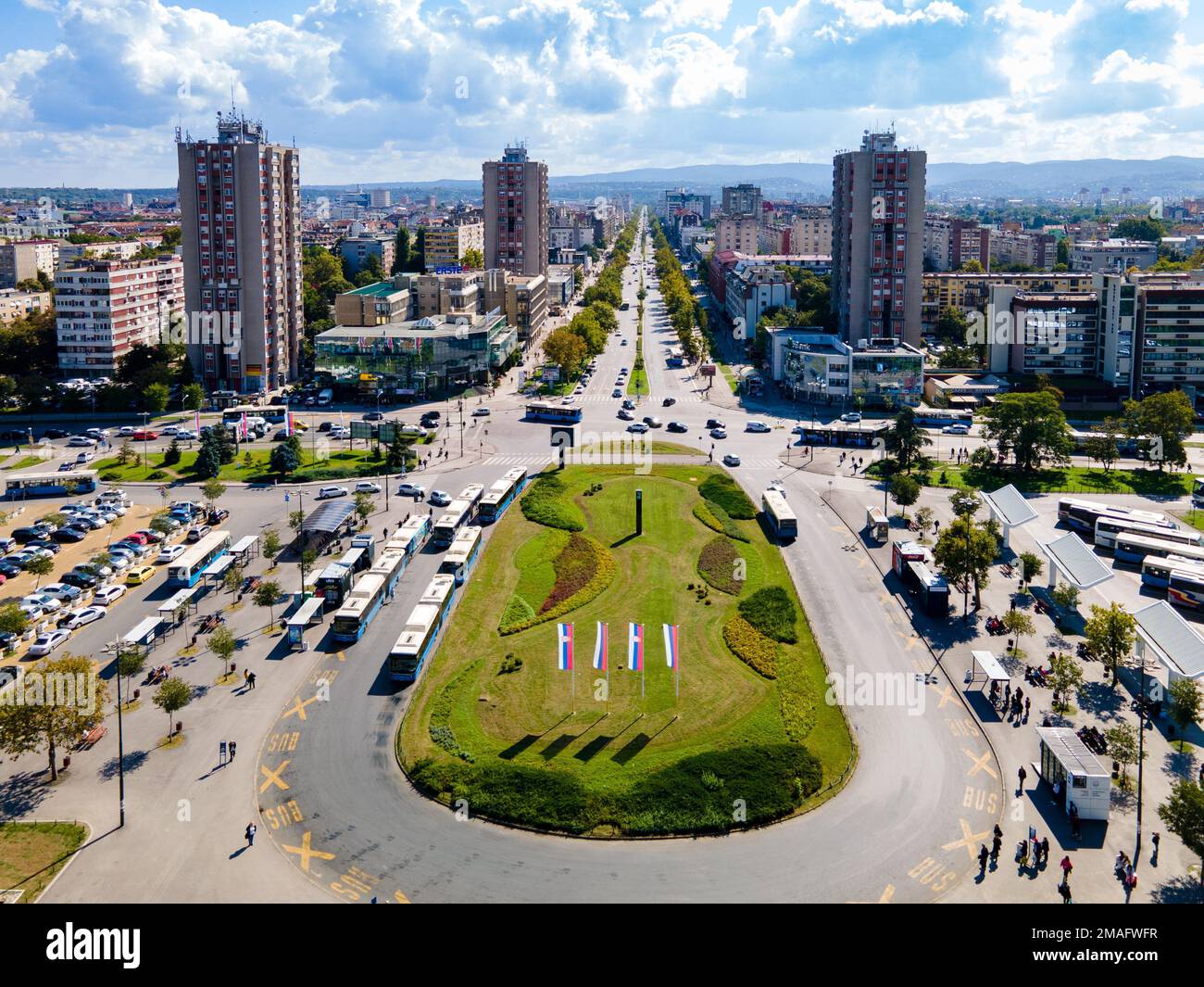 An aerial view of urban square with many cars parked nearby and ...