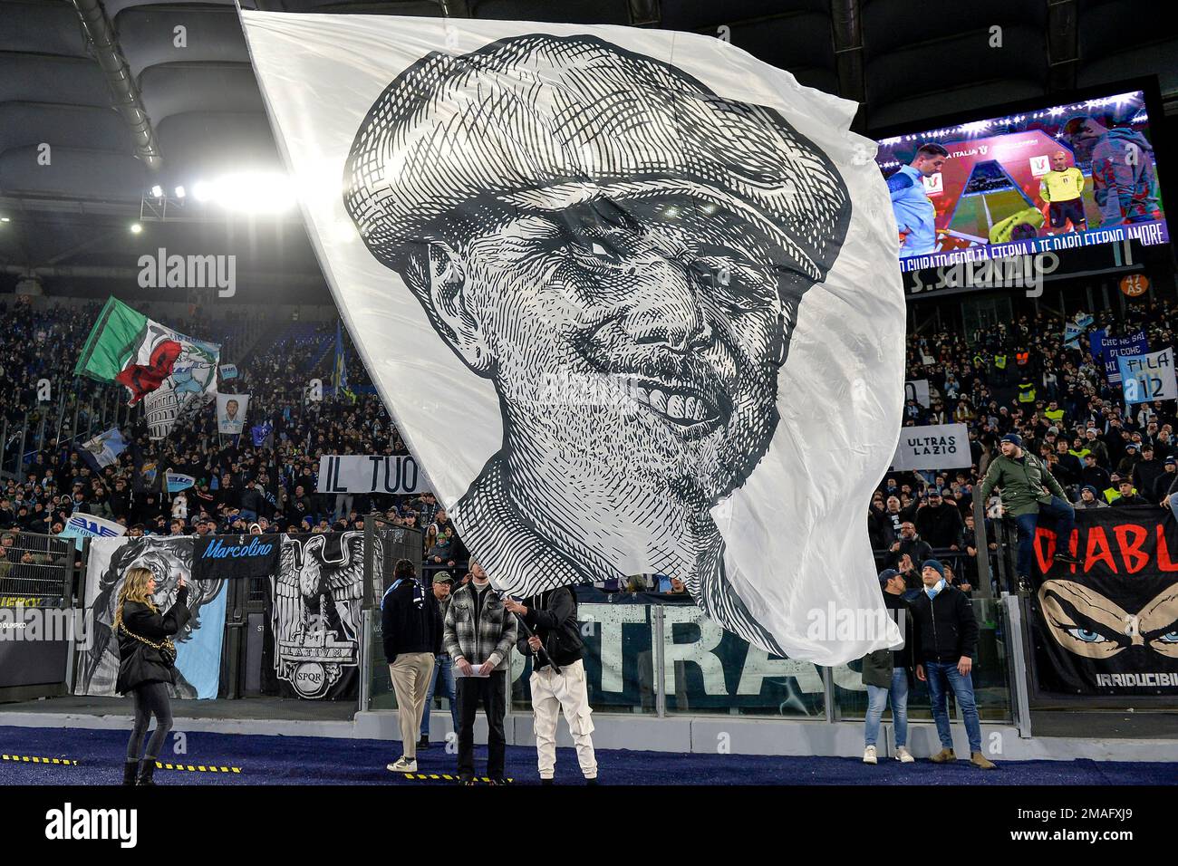 Roma, Italy. 19th Jan, 2023. Lazio fans wave a flag depictung Sinisa ...