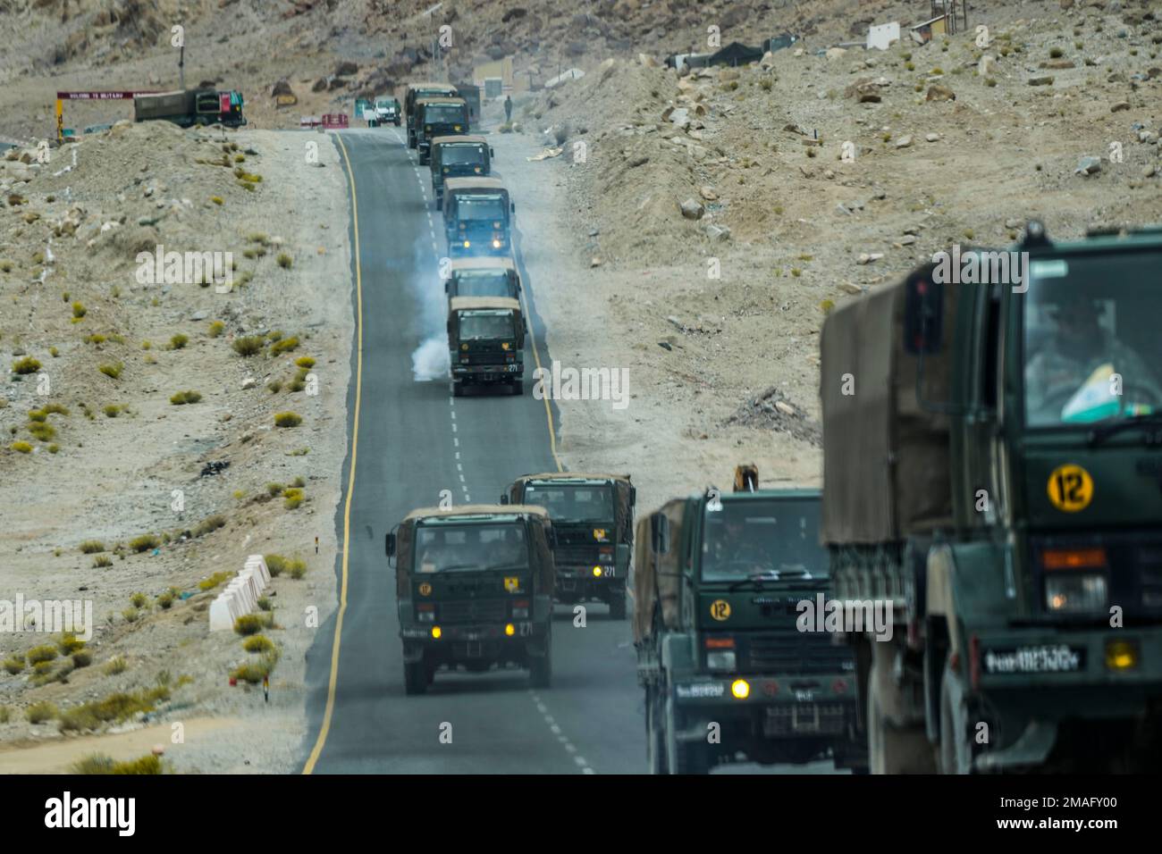 Indian army vehicles move in a convoy in the cold desert region of ...