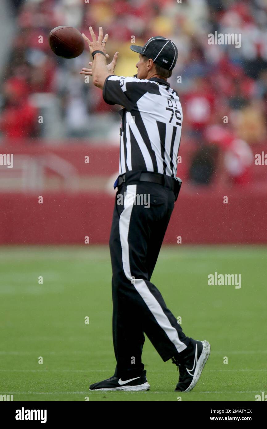 Down Judge Kent Payne (79) catches a ball during an NFL football game ...