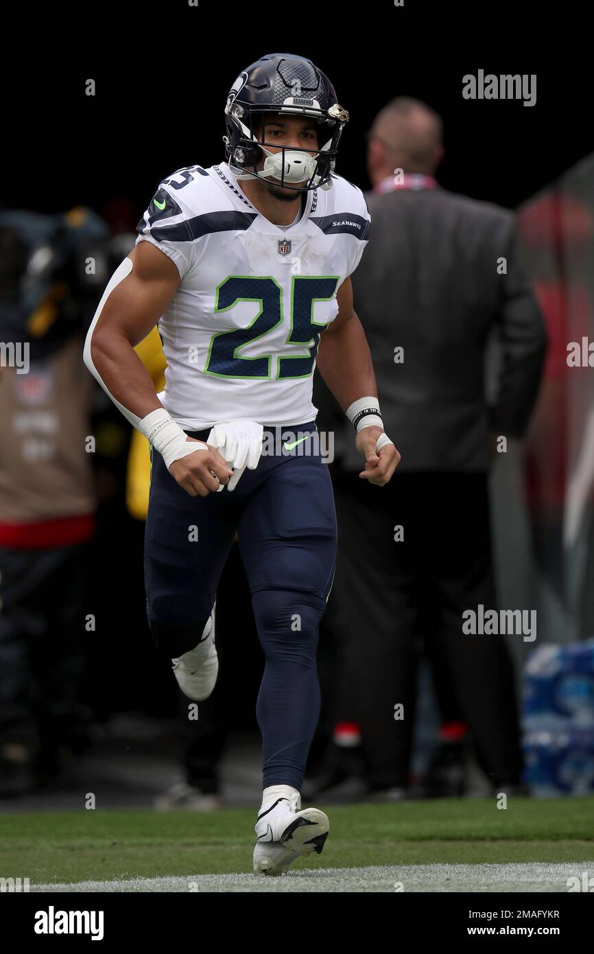 Seattle Seahawks running back Travis Homer (25) runs onto the field ...