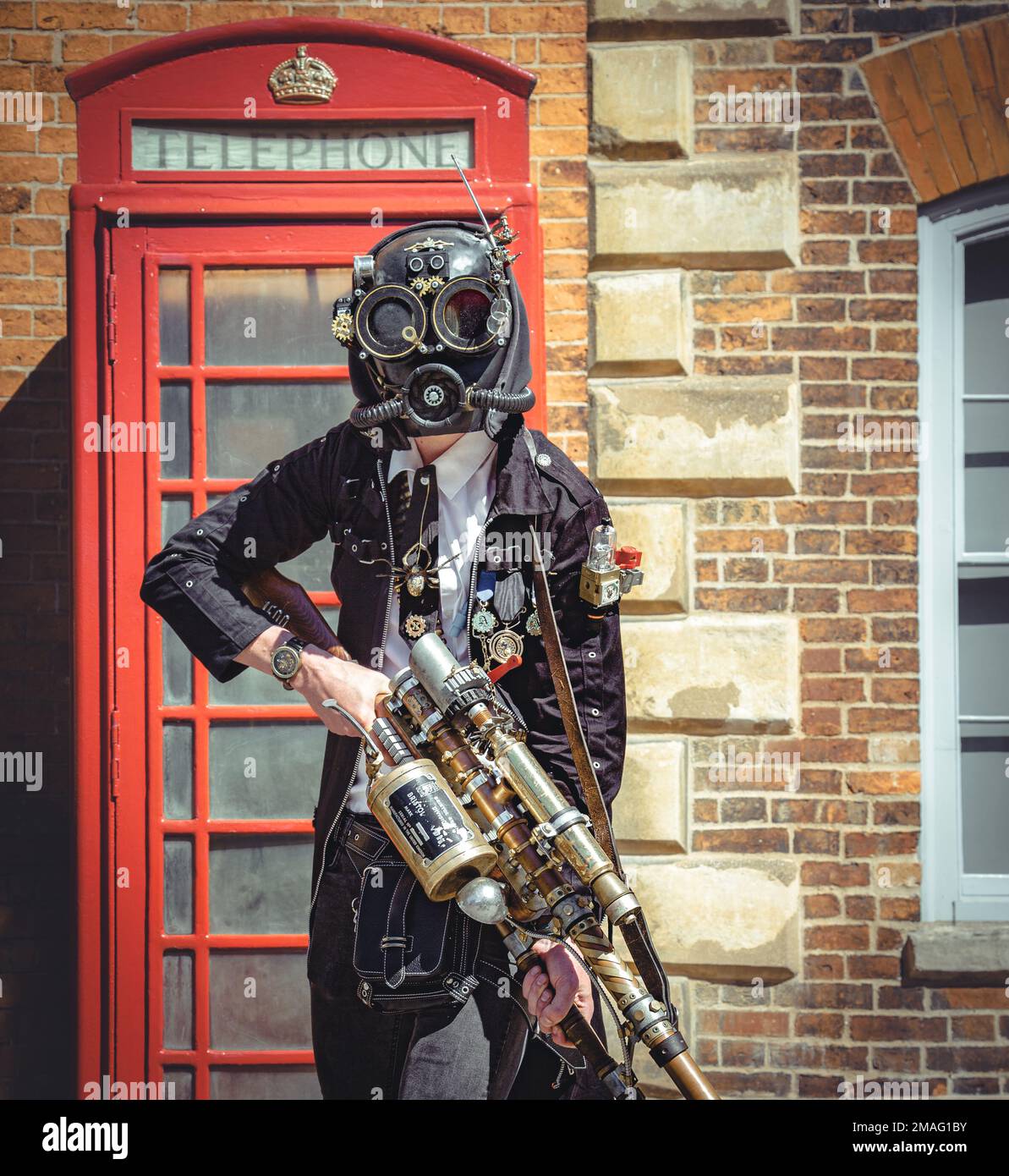 A retro futuristic steampunk holding a weapon standing in front of an ...