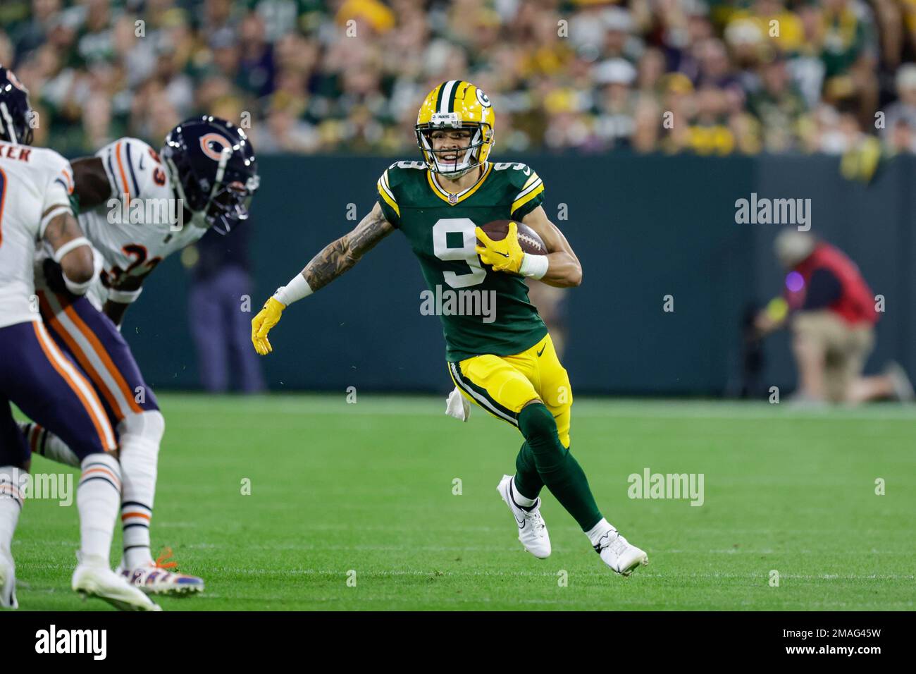 Green Bay Packers wide receiver Christian Watson runs after making a ...