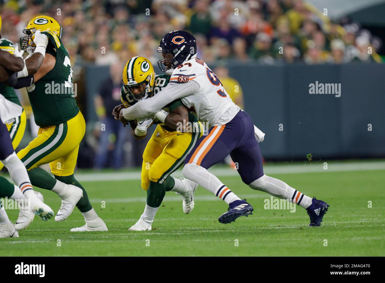 Green Bay Packers running back AJ Dillon is hit by Chicago Bears ...