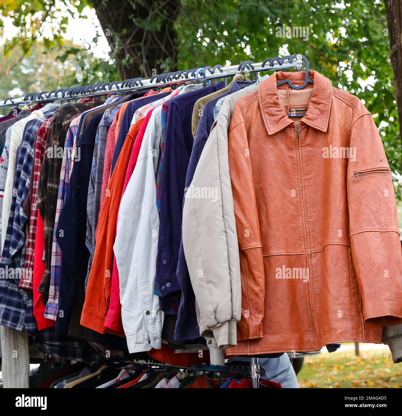 vintage used clothes and new dresses in the stall at the flea market ...