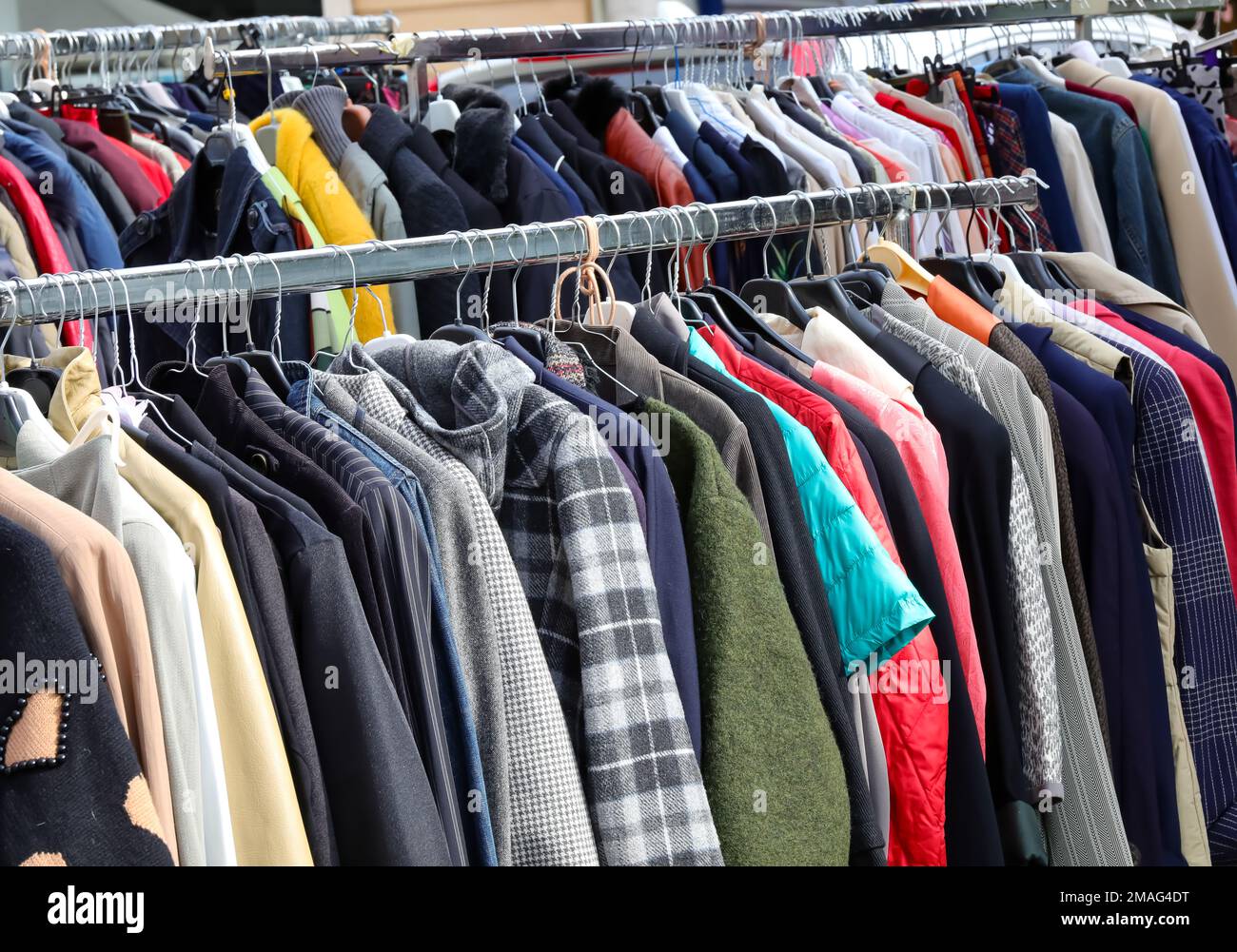 vintage used clothes and new dresses in the stall at the flea market ...