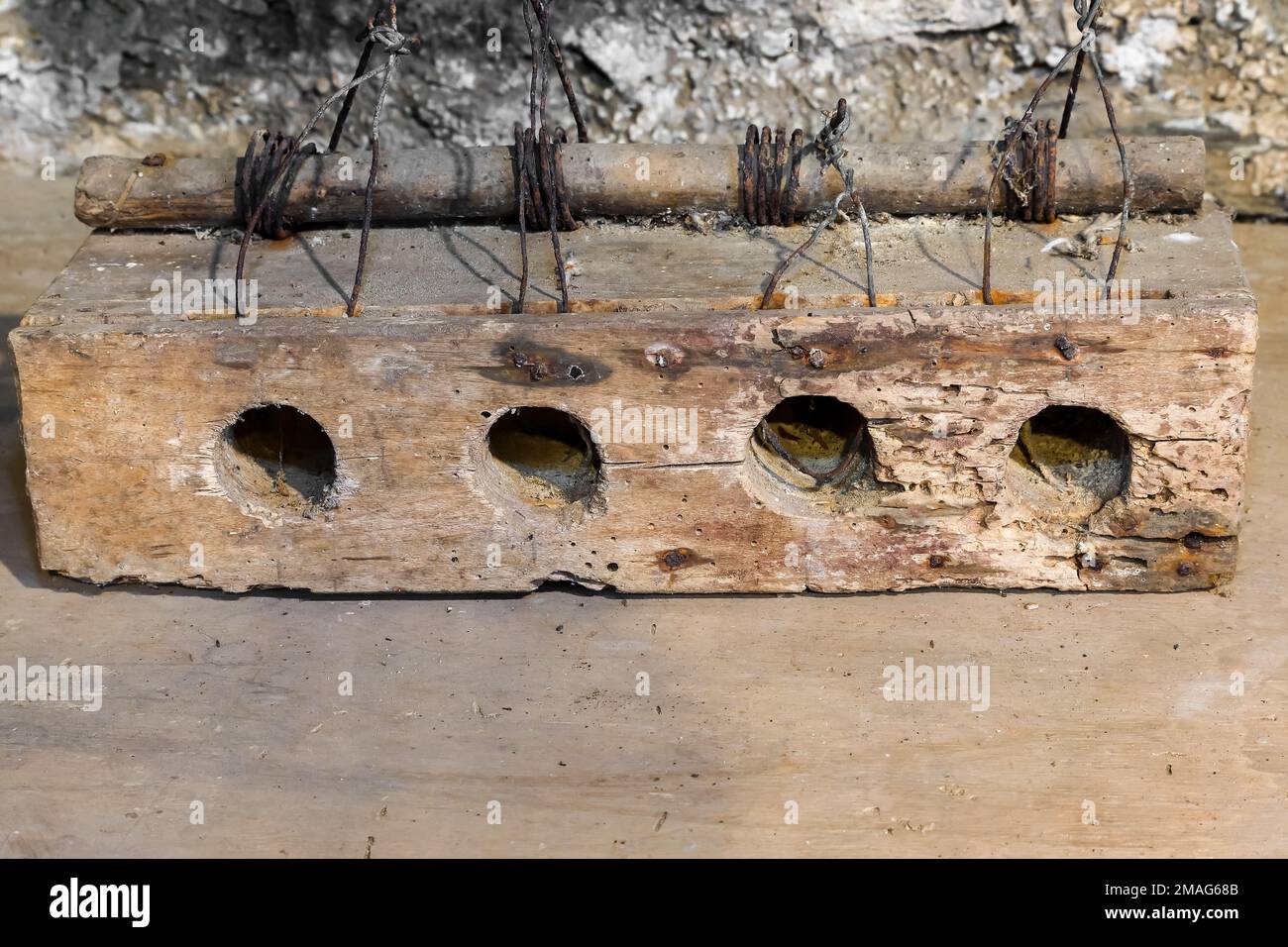 four holes of an ancient handmade trap to catch mice in the cellar of ...
