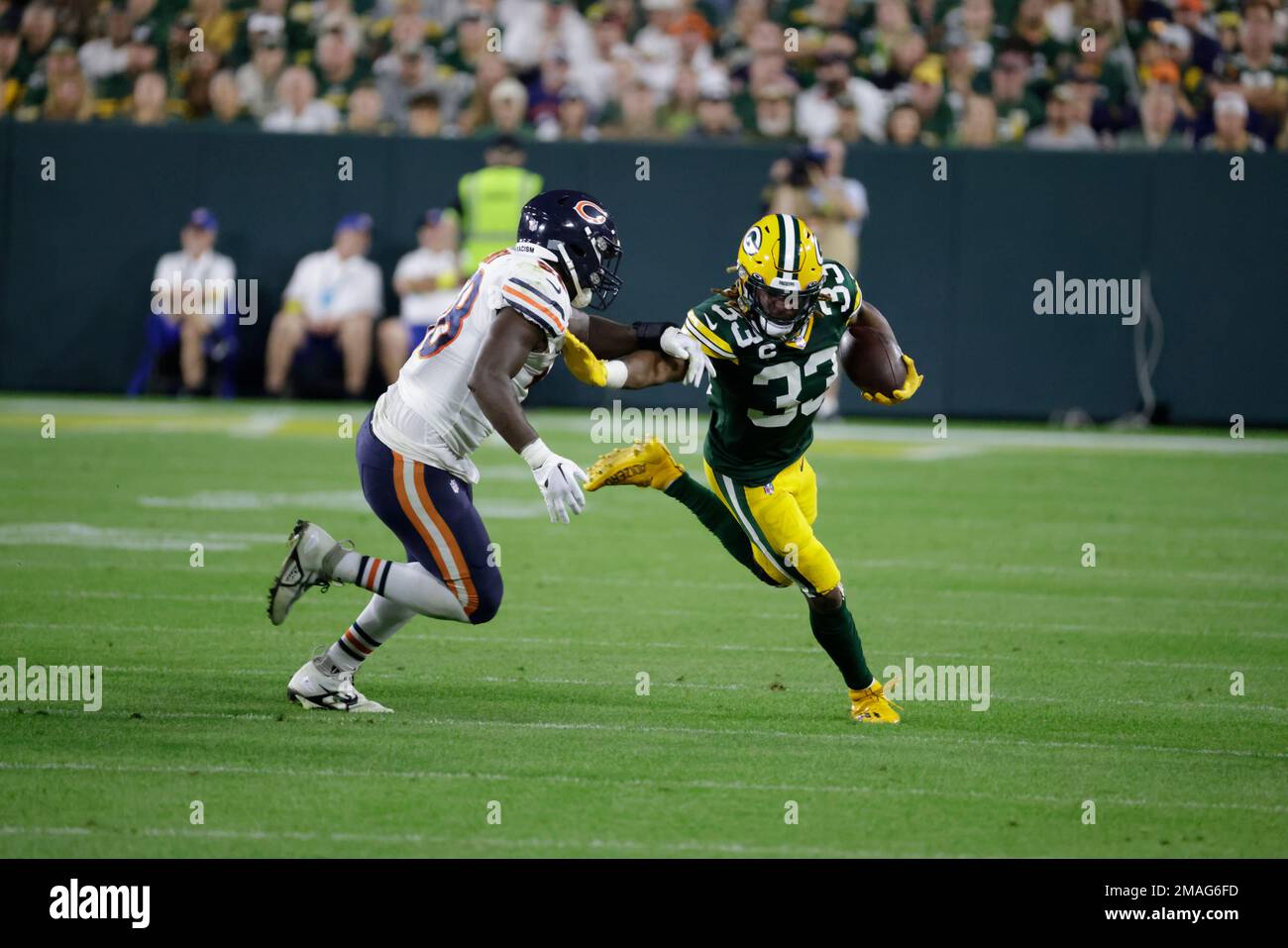 Green Bay Packers running back Aaron Jones (33) is tackled by Chicago ...