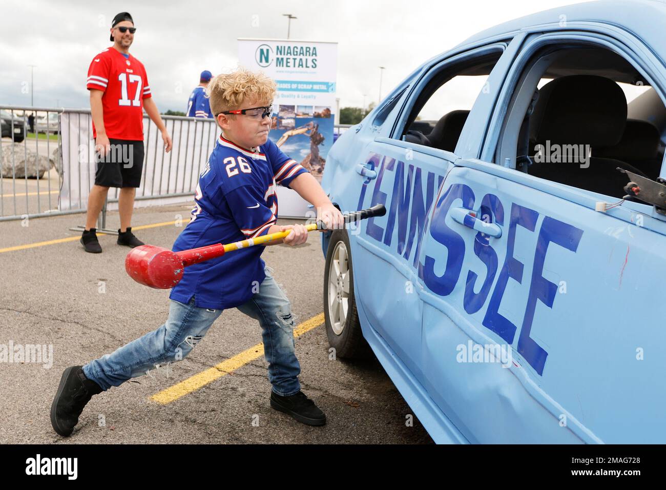 Buffalo Bills fan Finn Degroff, 10 hits a car with a sledge hammer ...
