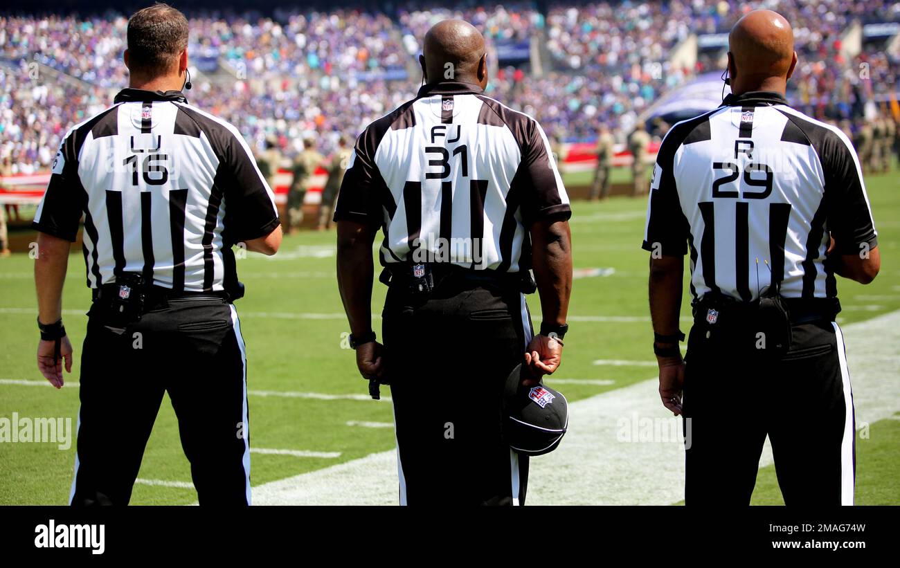 Down judge Kevin Codey (16), field judge Mearl Robinson (31) and ...