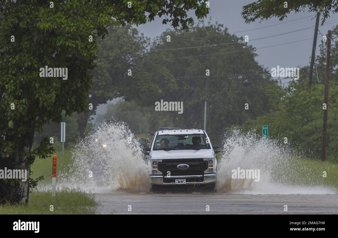 People drive through a street flooded by Hurricane Fiona in Salinas ...