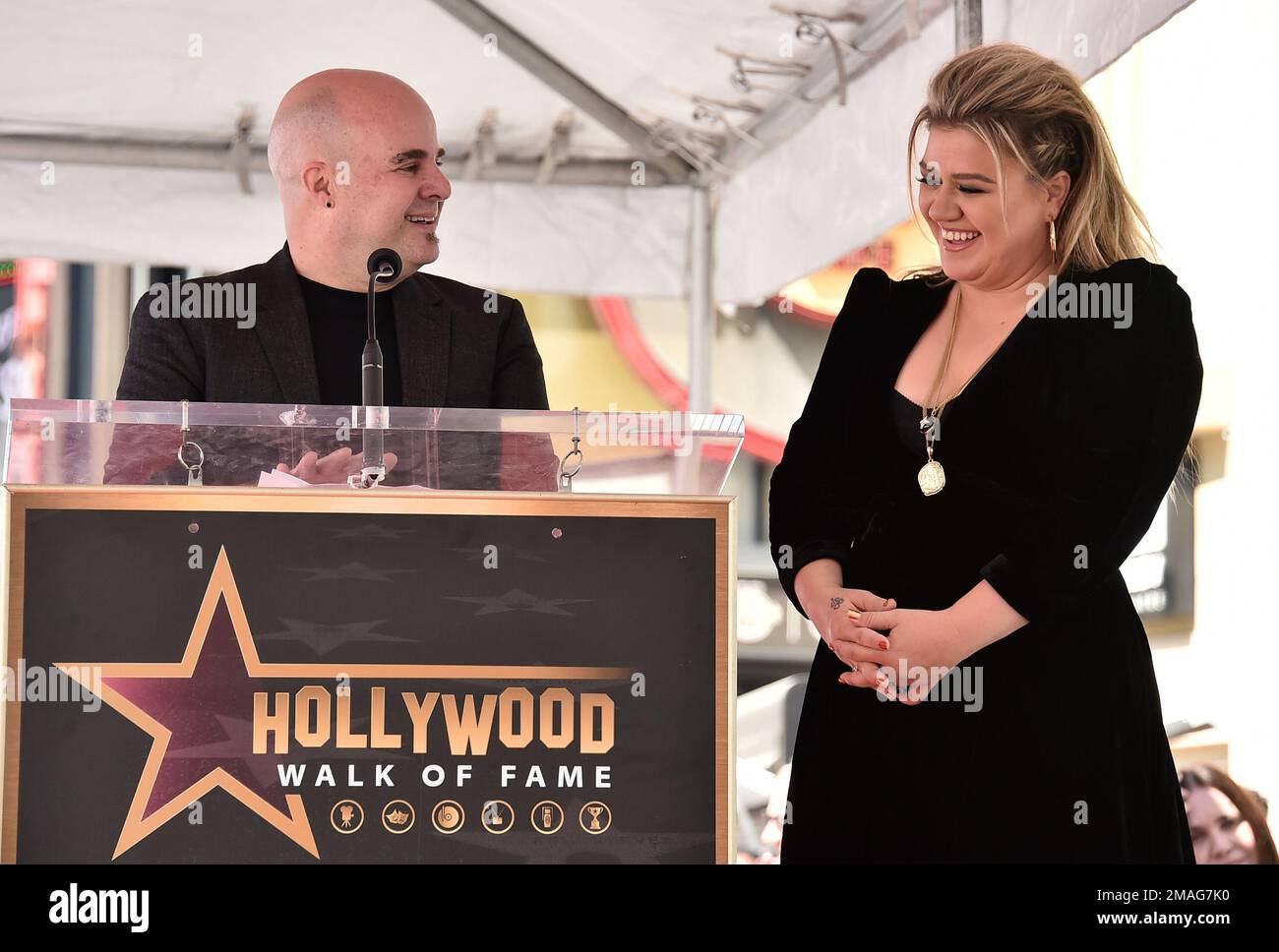 Music director Jason Halbert speaks as singer and television host Kelly ...