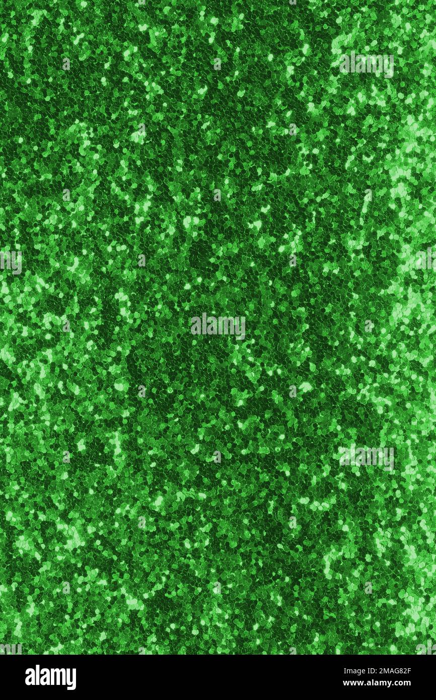 GREEN shimmering glitter material background with glowing effects and ...
