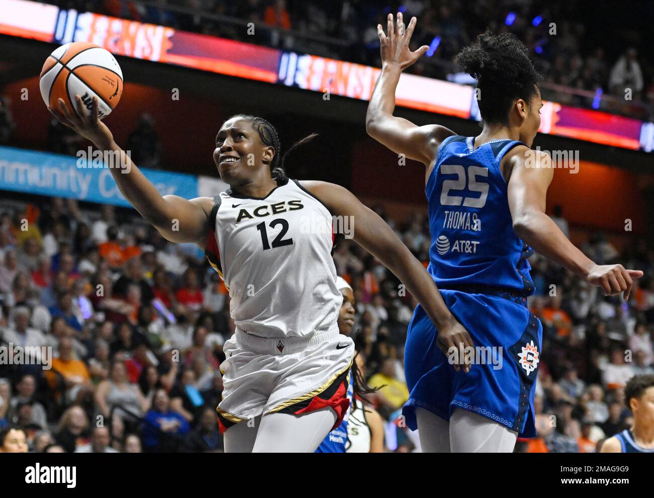 Las Vegas Aces' Chelsea Gray shoots as Connecticut Sun's Alyssa Thomas ...