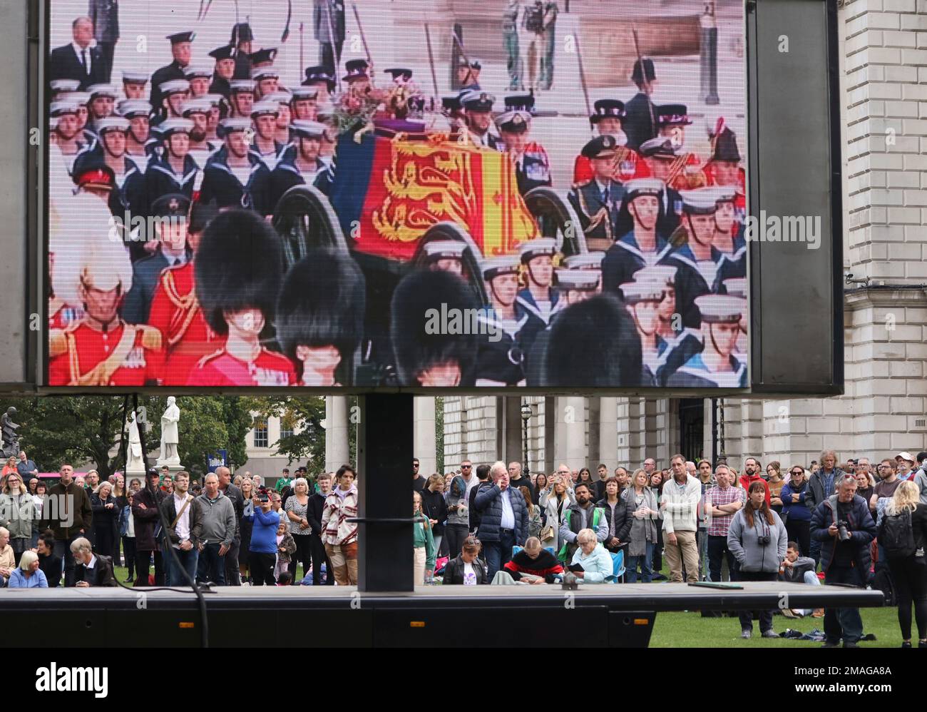 People gather at Belfast city hall, Northern Ireland to watch TV coverage of the funeral of ...