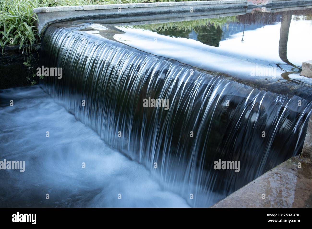 A miniature waterfall that creates a mirrored surface and a silky flow ...