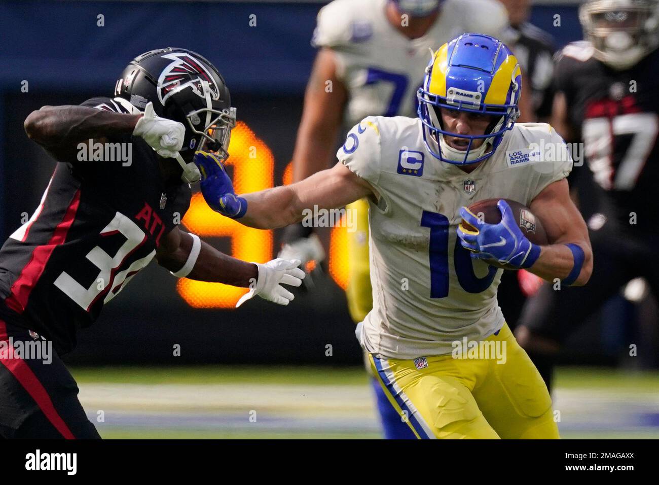 Los Angeles Rams wide receiver Cooper Kupp, right, fends off Atlanta ...