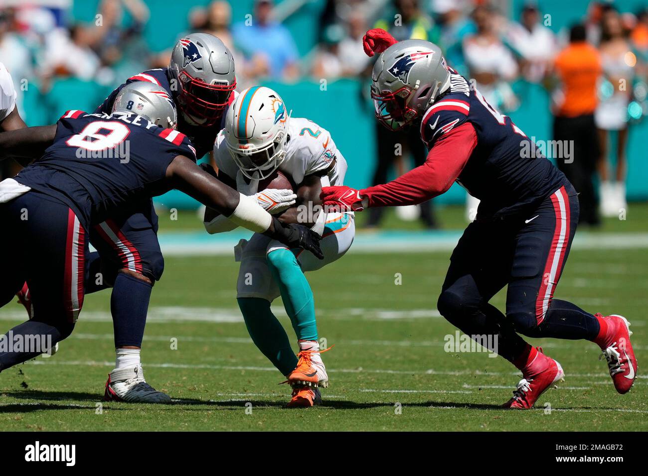 Miami Dolphins running back Chase Edmonds (2) is surrounded by New ...