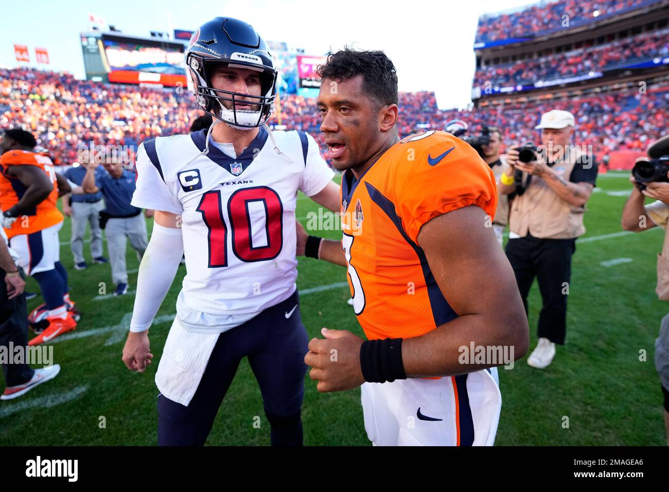Denver Broncos quarterback Russell Wilson, right, greets Houston Texans ...