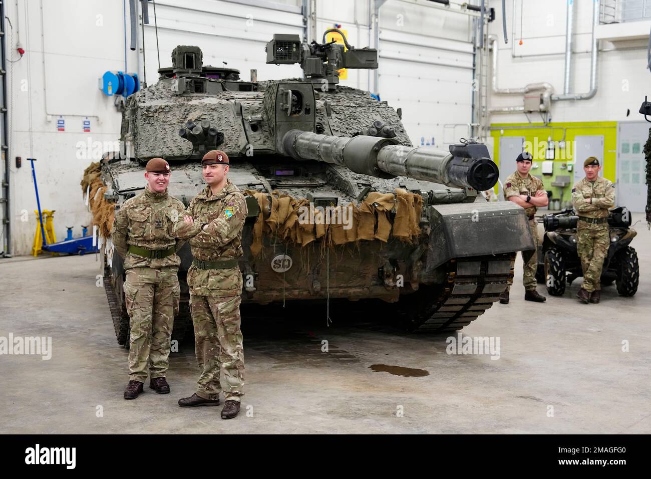 Britain's military officers stand next to a Challenger 2 tank at the ...