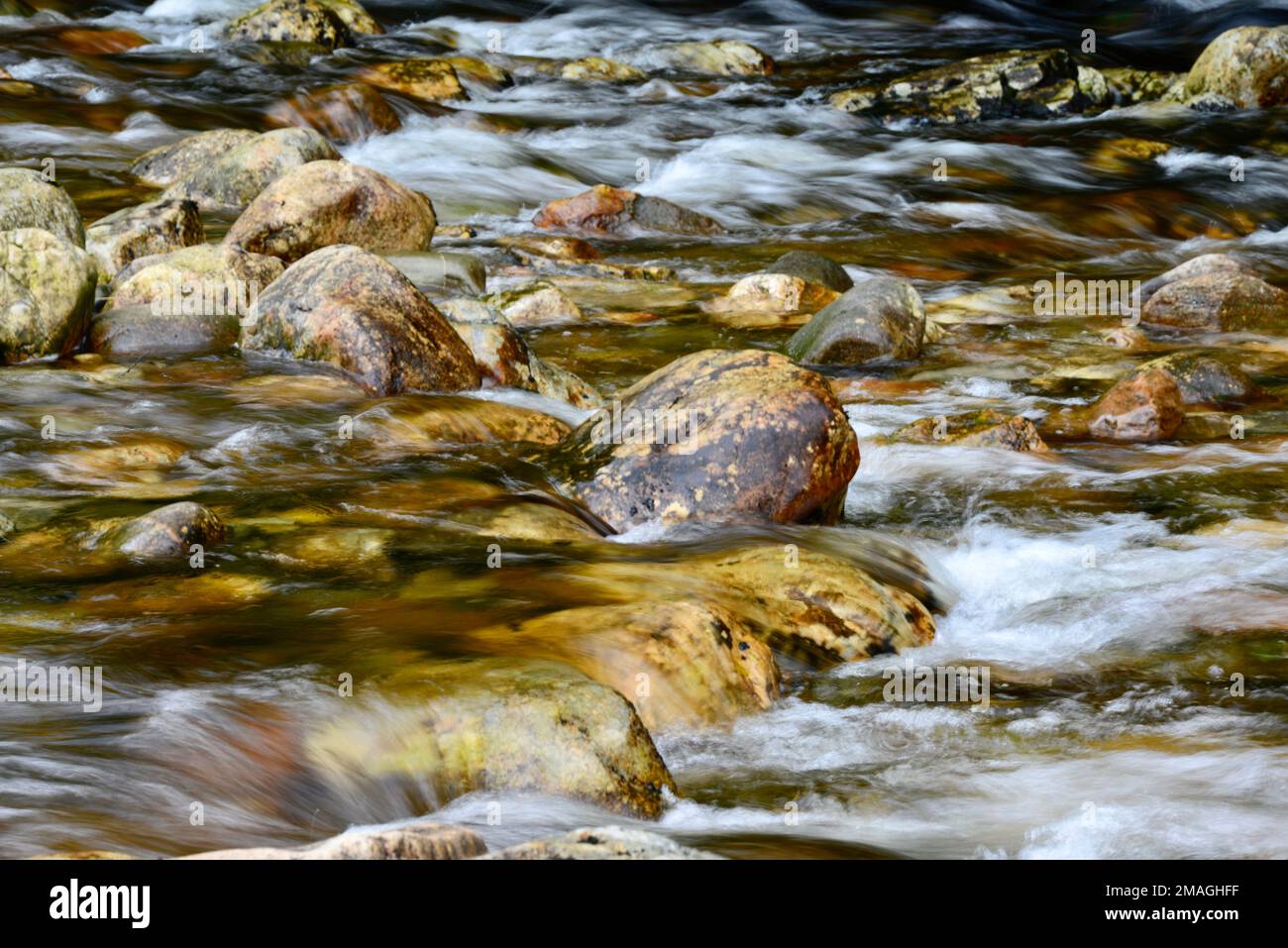 A stream flowing through pebbles, long exposure Stock Photo - Alamy