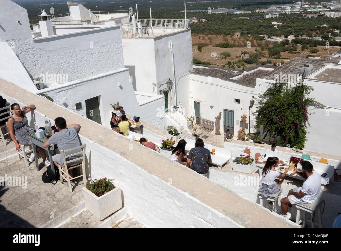 people chatting and relaxing in the city of Ostuni, Puglia, Italy Stock ...