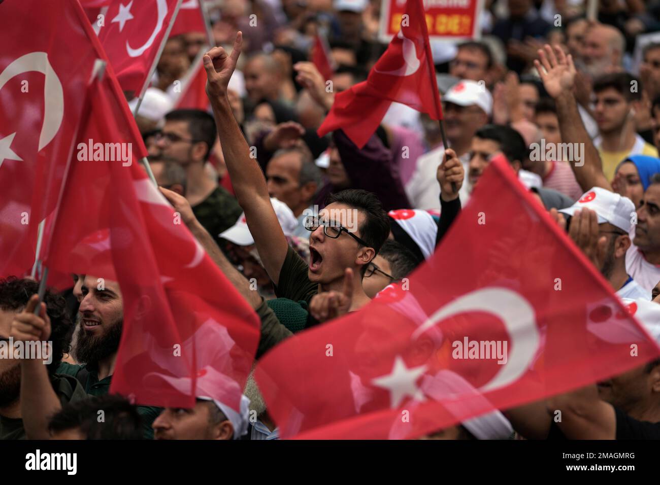 Turkish demonstrators chant slogans while holding Turkish flags during ...