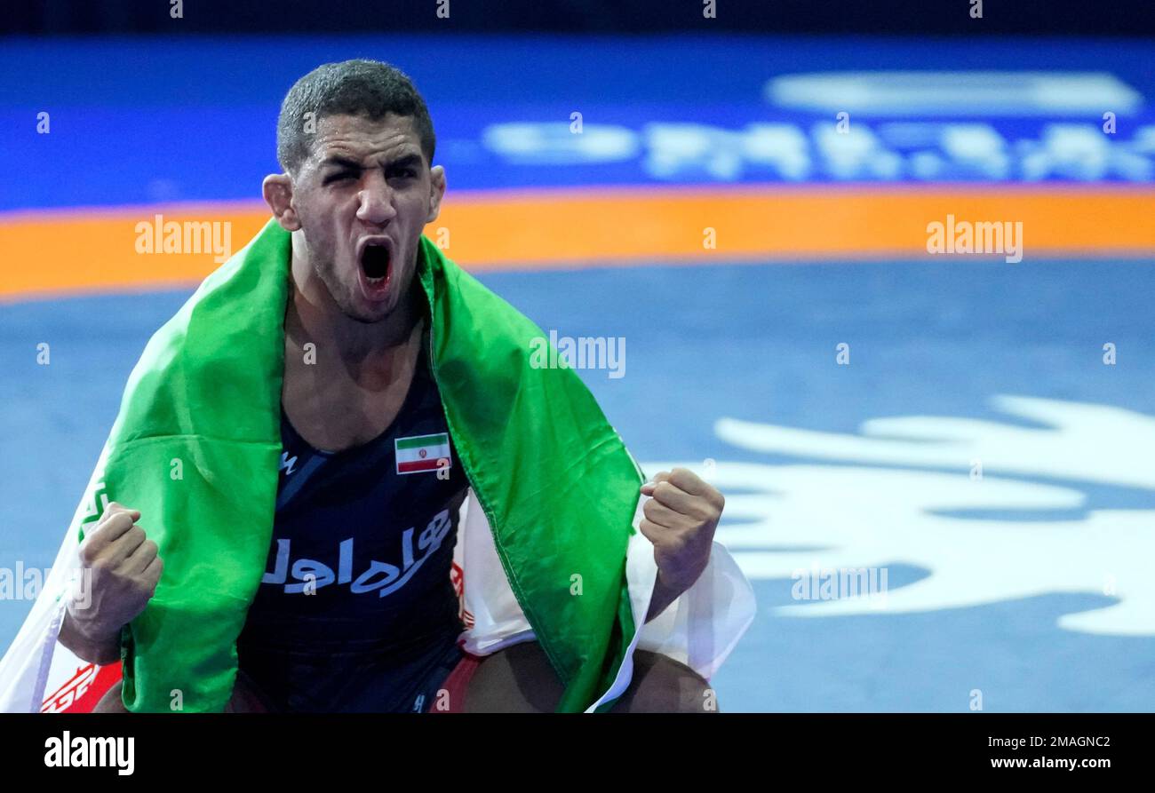 Iran's Rahman Mousa Amouzadkhalili celebrates after his men's freestyle ...