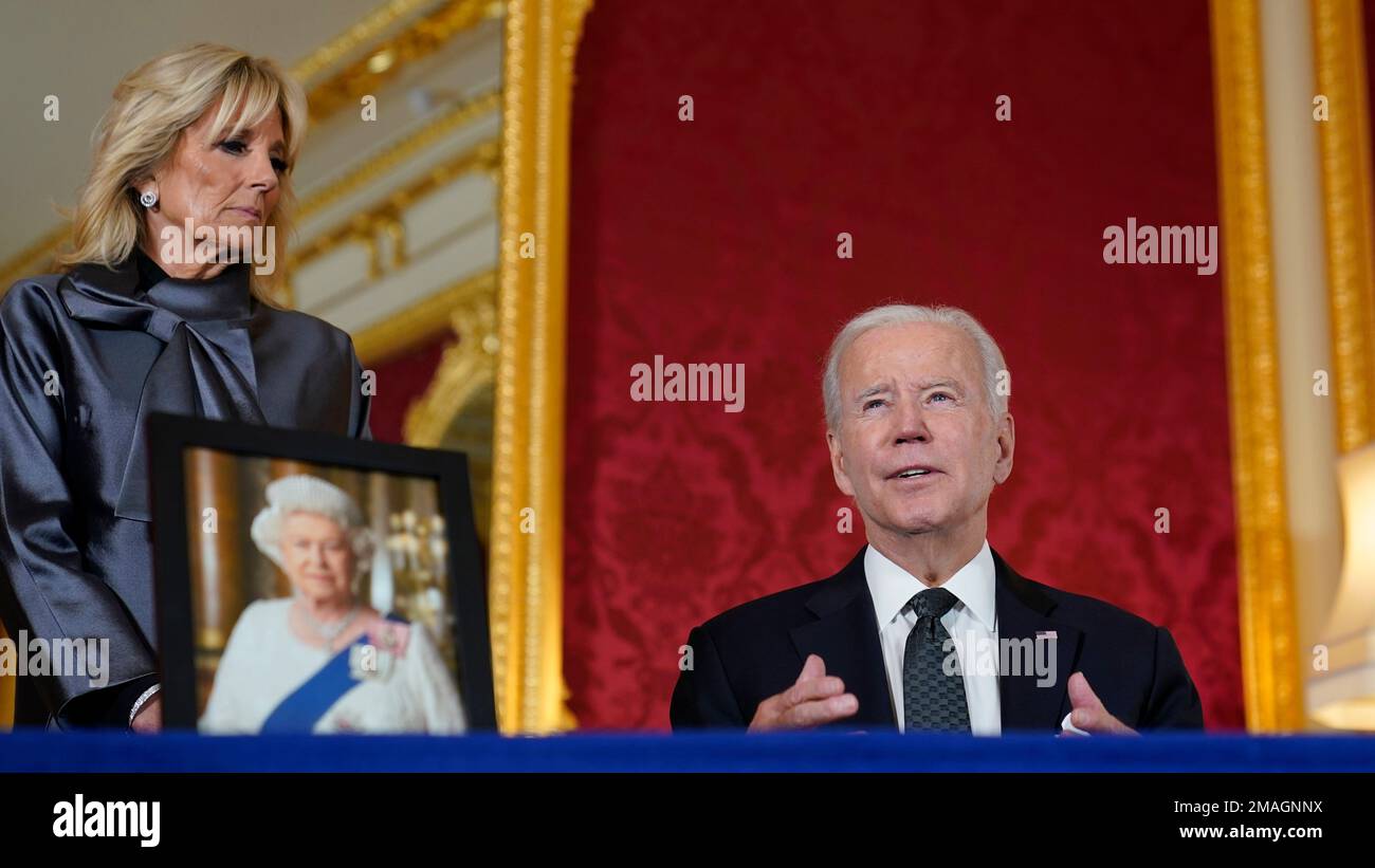 President Joe Biden signs a book of condolence at Lancaster House in ...