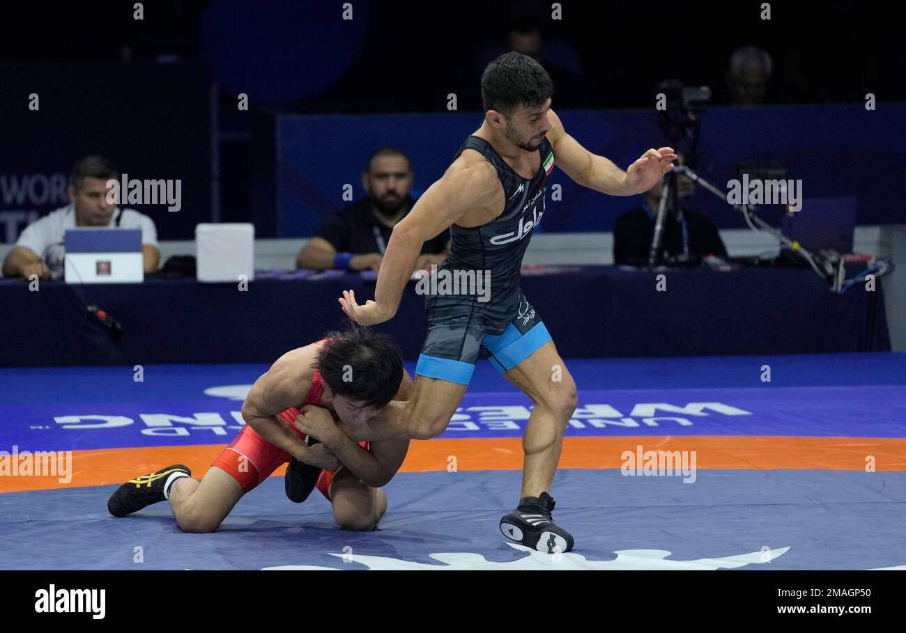 Japan's Rei Higuchi, left, and Iran's Reza Ahmadali Atrinagharchi ...