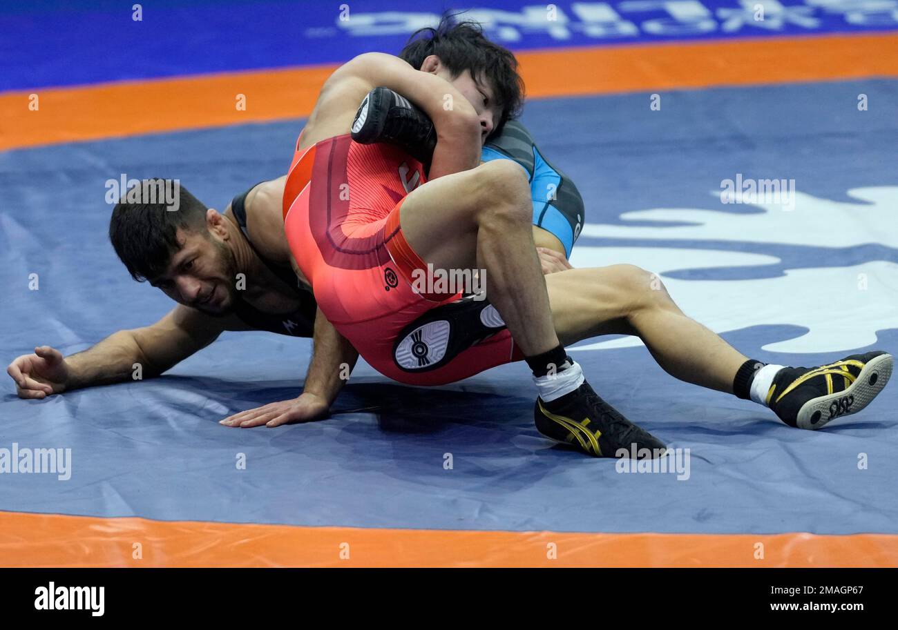 Japan's Rei Higuchi, right, and Iran's Reza Ahmadali Atrinagharchi ...