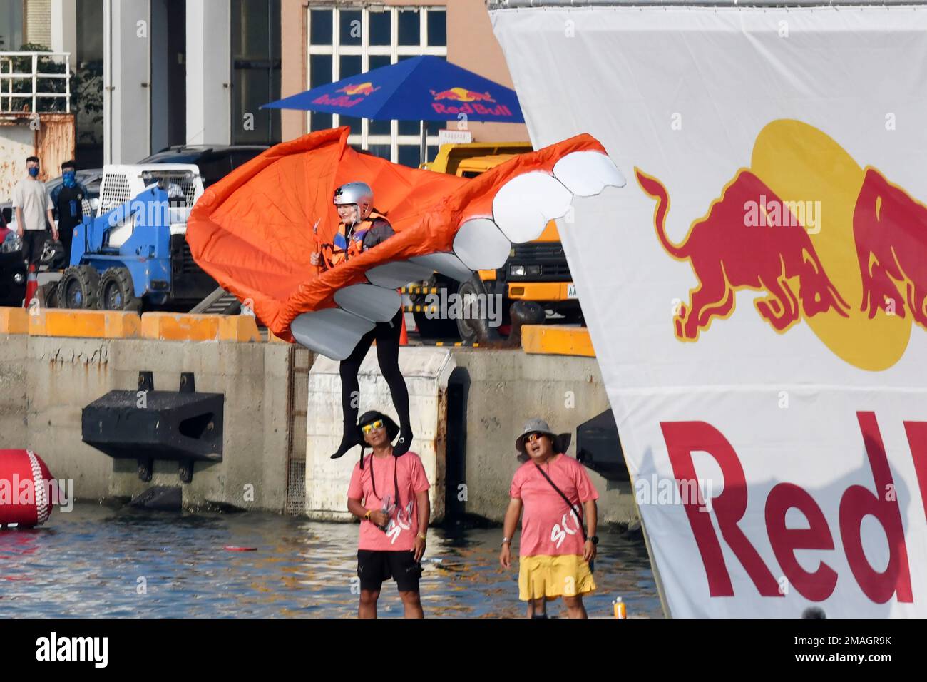 A team member jumps from a platform with a man made flying machine into ...