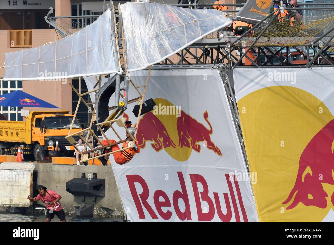A team member jumps from a platform with a man made flying machine into ...