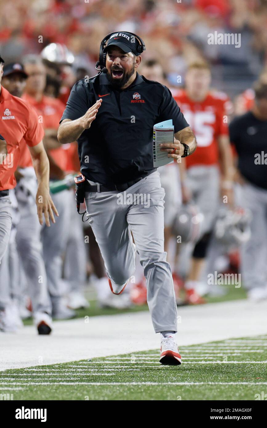 Ohio State coach Ryan Day runs toward an official to call a timeout ...
